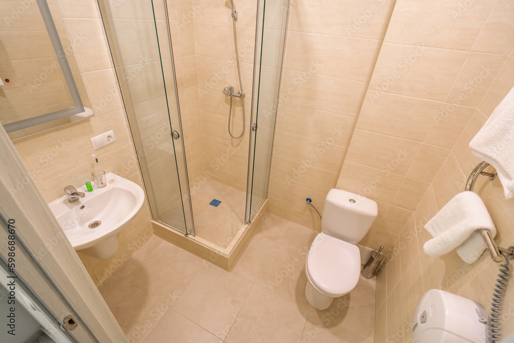 a bathroom in a modern inpatient clinic a toilet a shower cabin a sink ...