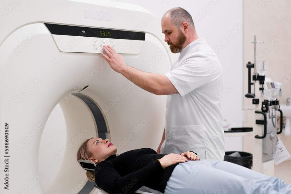 A radiologist performs a computer tomography procedure in a medical ...
