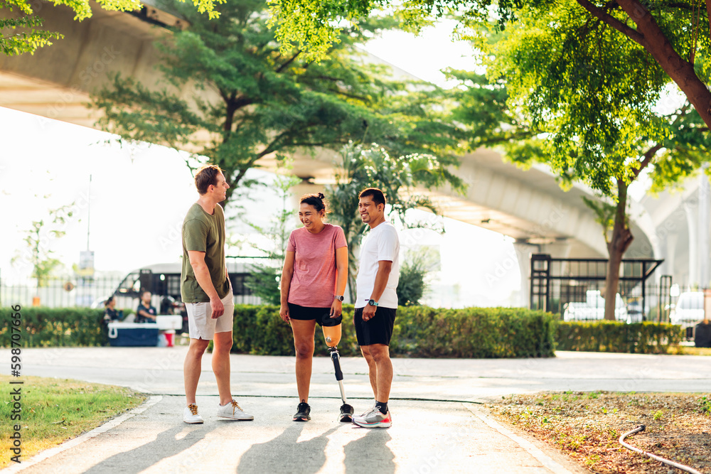 Friend support Friend with a prosthetic leg while exercising outdoor ...