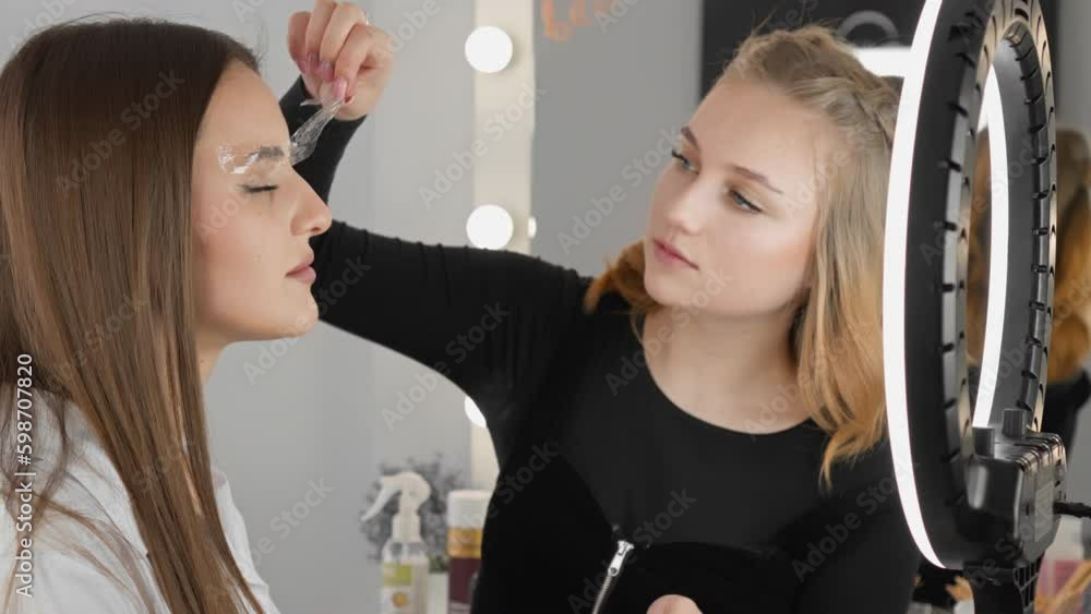 Beautician, eyebrow master demonstrates the process of creating ...