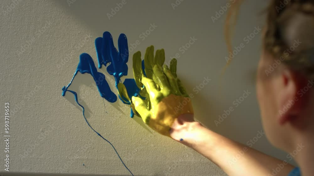 A talented girl creates a creative picture with her hands and fingers ...