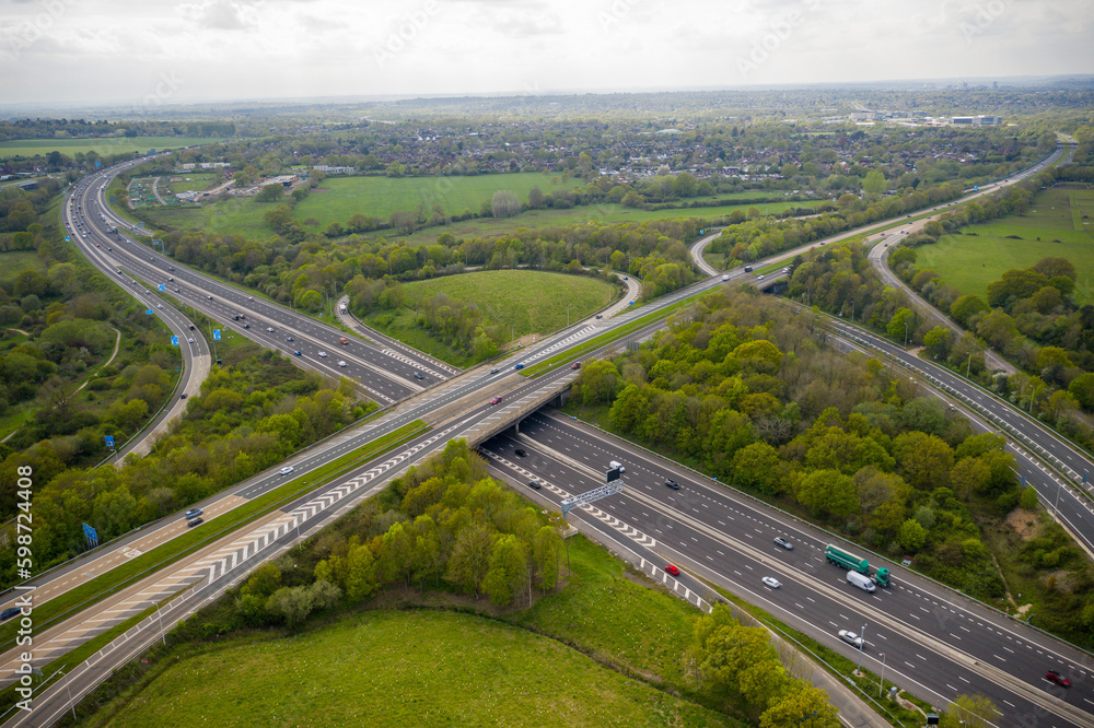 Flying over a busy motorway , lots of turns , lanes and intersections ...