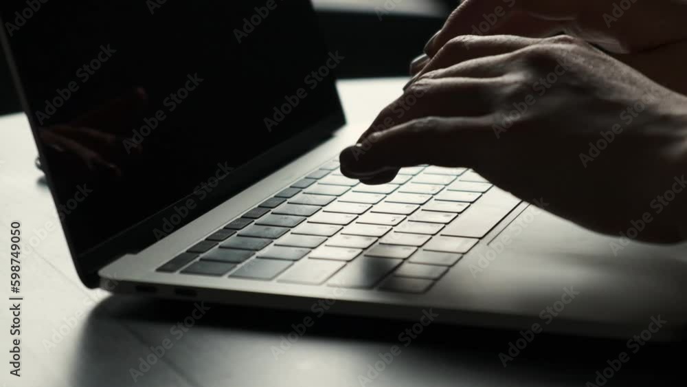 Close up side view of female hands typing on a laptop keyboard. Laptop ...