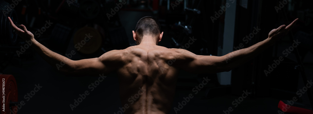 Back view of shirtless man with sculpted body in gym. Generative AI ...