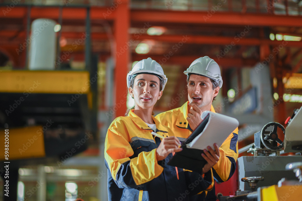 two young engineer assistant in helmet inspection check heavy machine ...