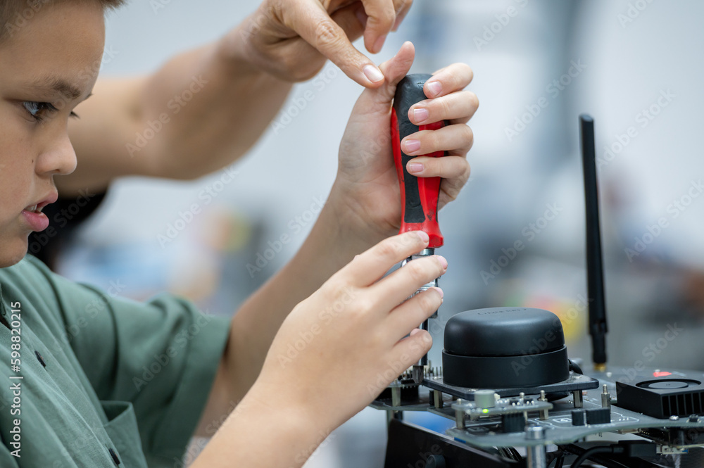 Boy male teen child concentrate enjoy Machine Learning Robot is Moving ...