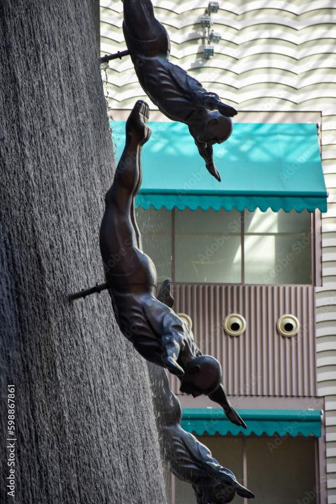 An aesthetic close-up image of a group of divers hanging statues in the ...
