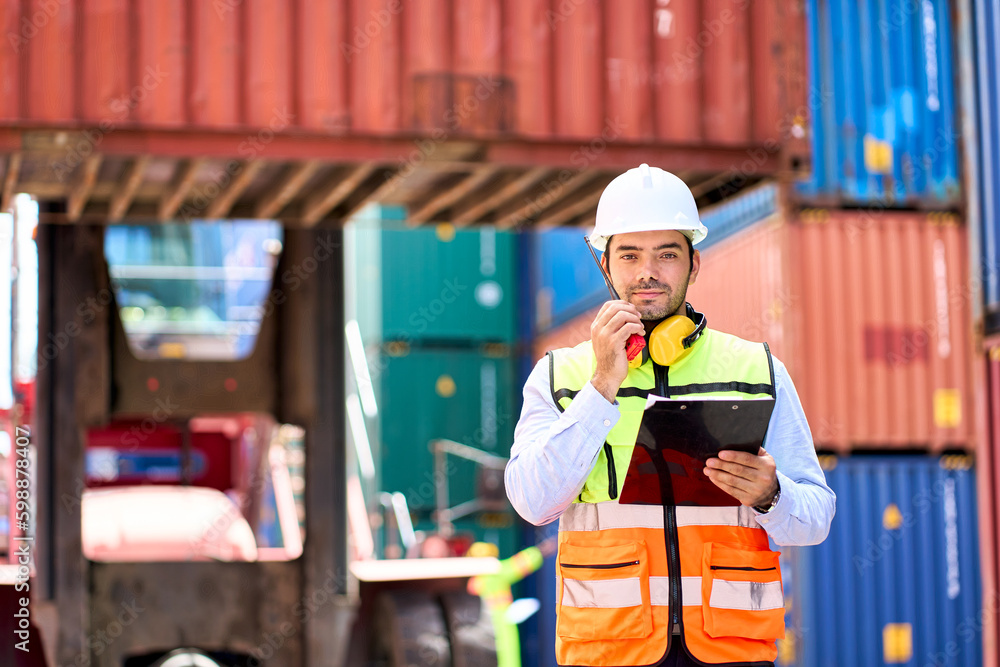 Foreman check a paper chart and communicate with team by walkie talkie ...