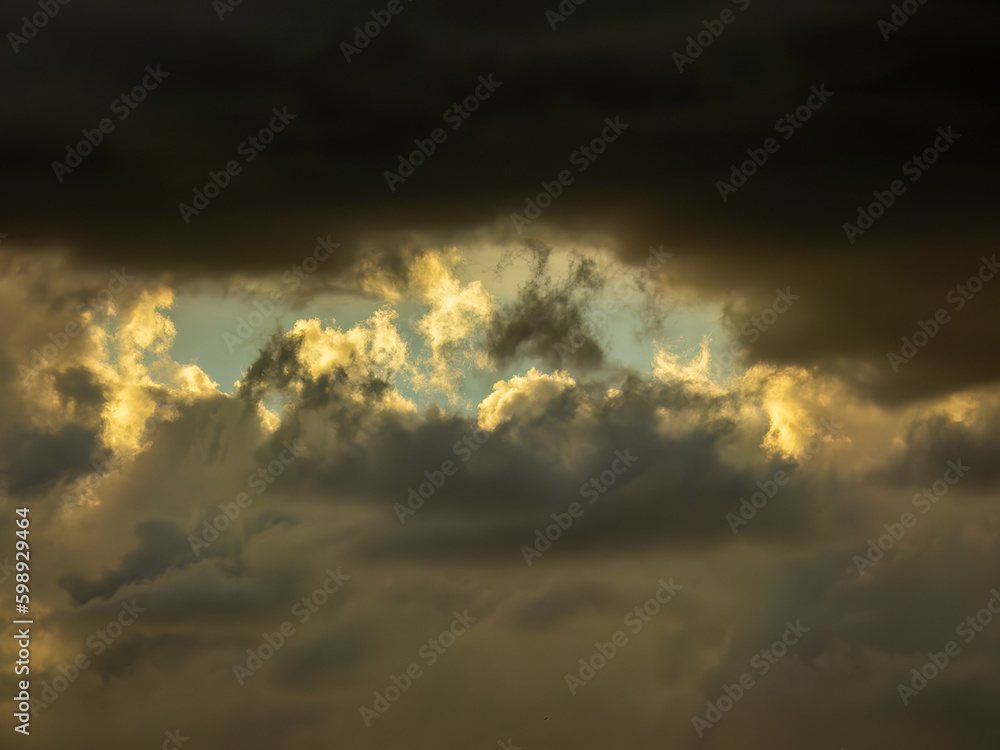 Dramatic cloudscape at sunset, with high contrast of dark storm clouds ...