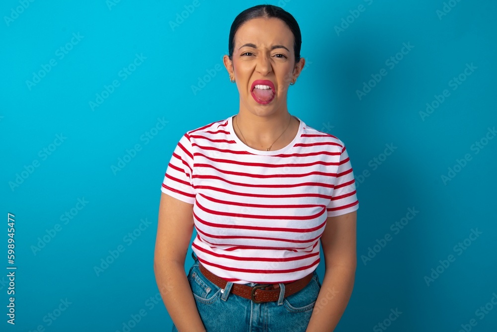 Body language. Disgusted stressed out beautiful woman wearing striped T ...