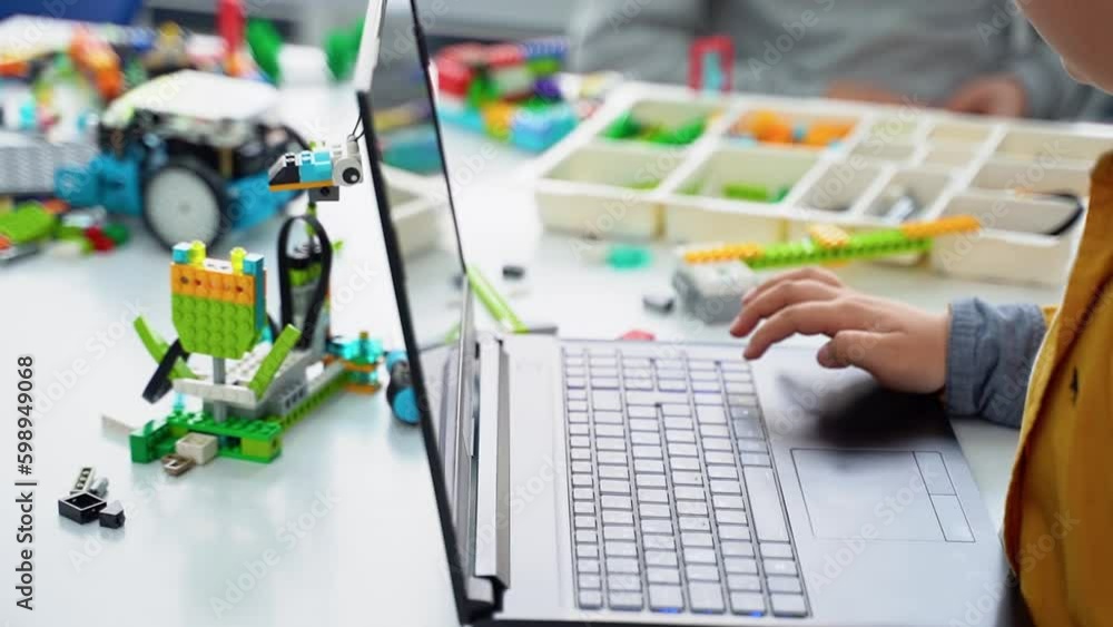 Robotics programming class. Children construct and code Robot. STEM ...