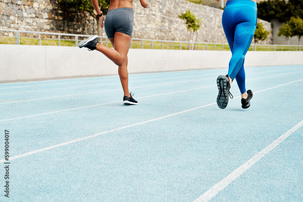 We run at the same pace. two unrecognizable athletes running along a ...
