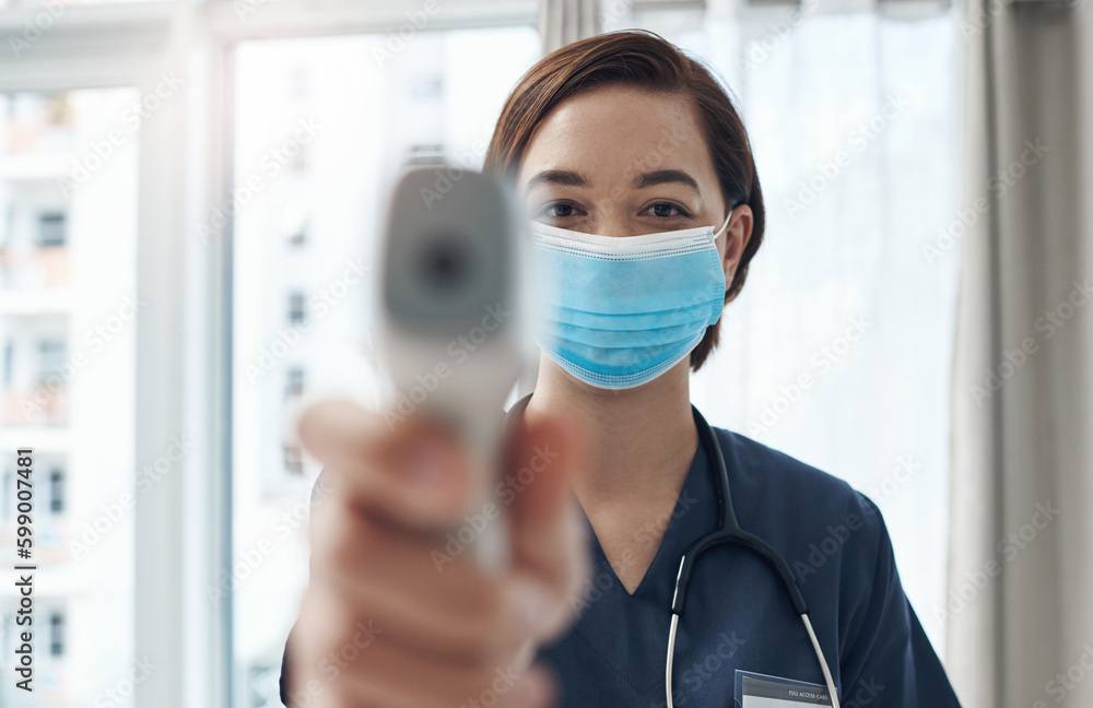 Dont forget to check your temperature. a young female doctor pointing a ...