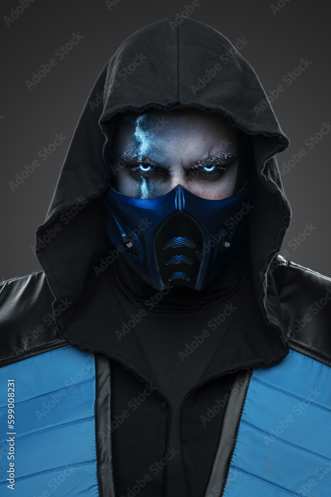 Portrait of Ice ninja with scar dressed in costume with hood staring at ...