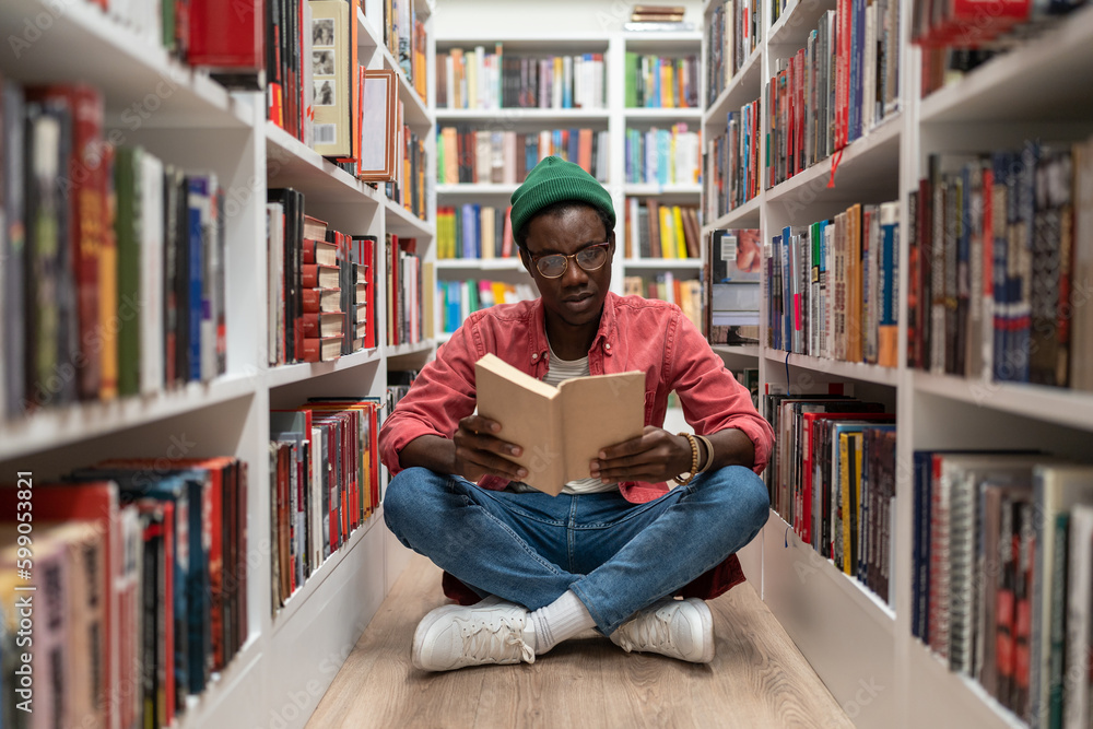 Student african american man reading research textbook in university ...