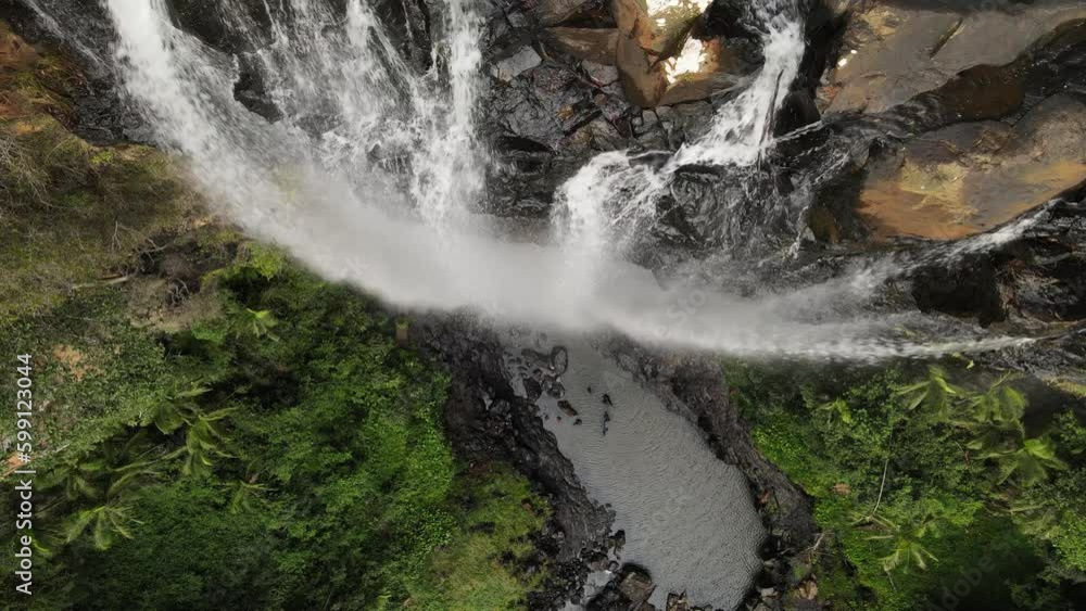 Looking down over a waterfall as water cascade down to a natural ...