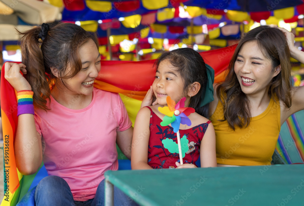 young asian lesbian couple take care of kid as a daughter, they are ...