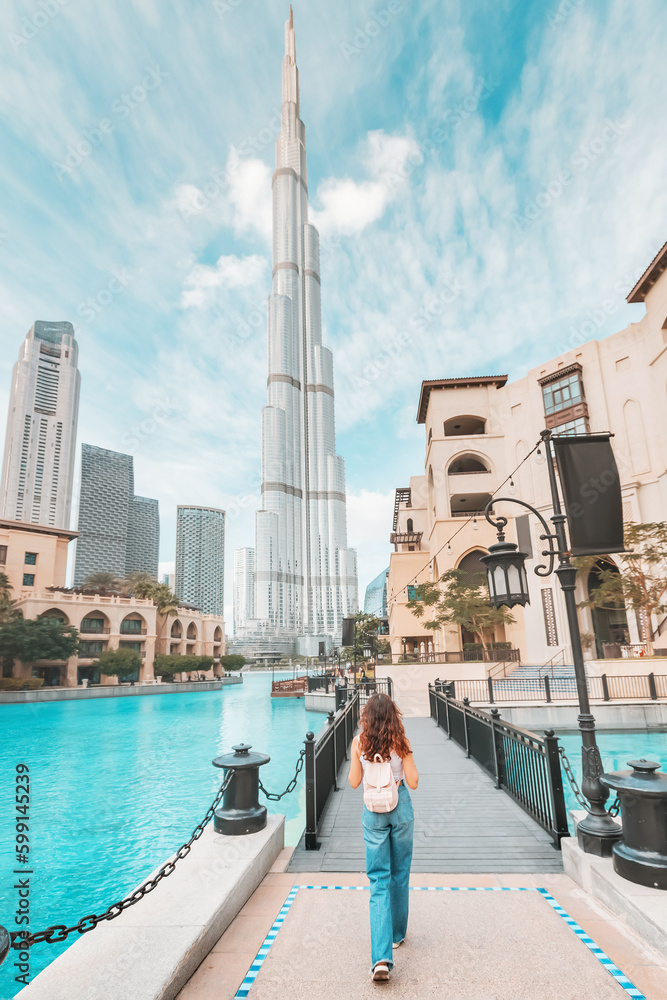 18 January 2023, Dubai, UAE: Back view of a happy girl walking and ...
