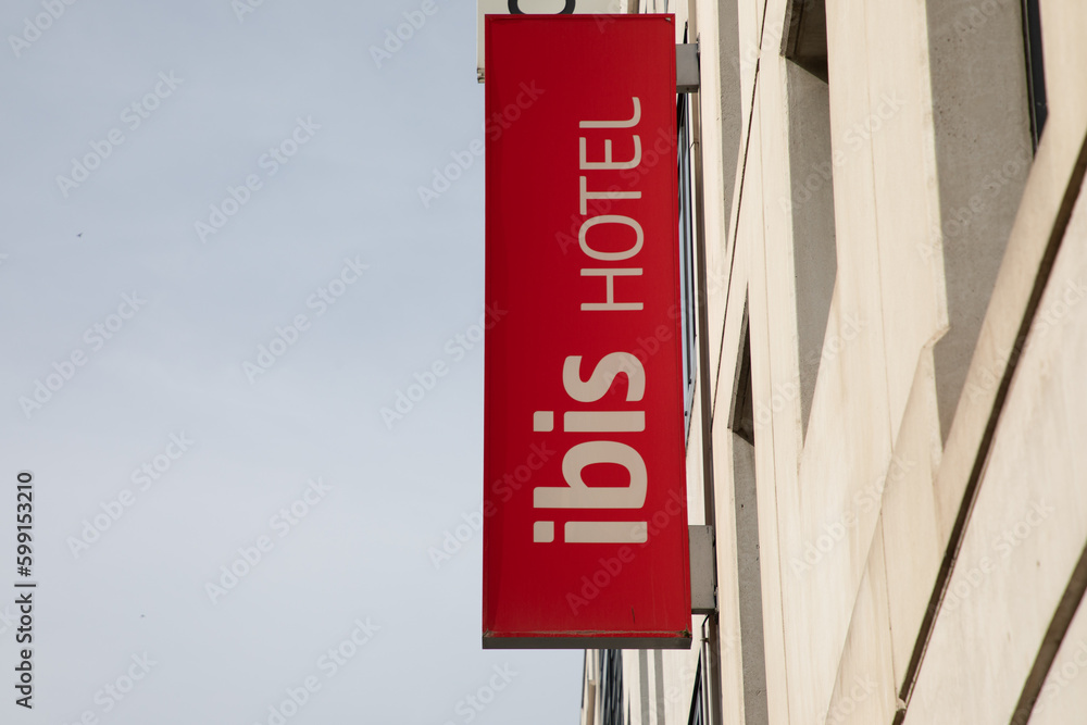 Ibis hotel sign red logo building entrance and brand text signage ...