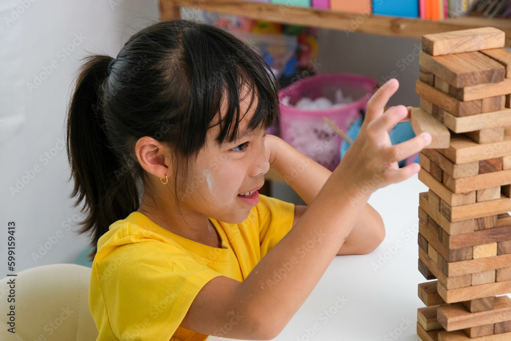 Cute Asian siblings having fun playing Jenga together. Two children ...