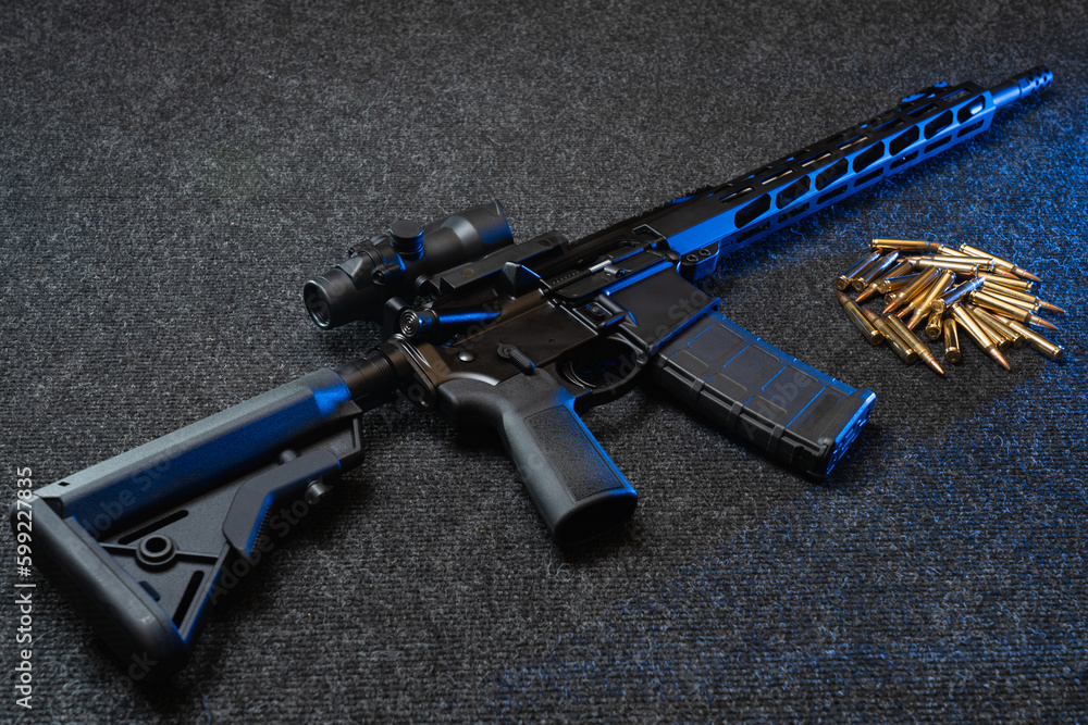 Shooting guns in a shooting range, ar 15 rifle and ammo in blue light ...