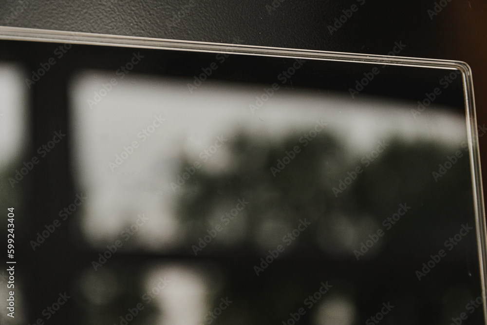 Reflective surfaces of a futuristic induction hob in black. A fuzzy ...