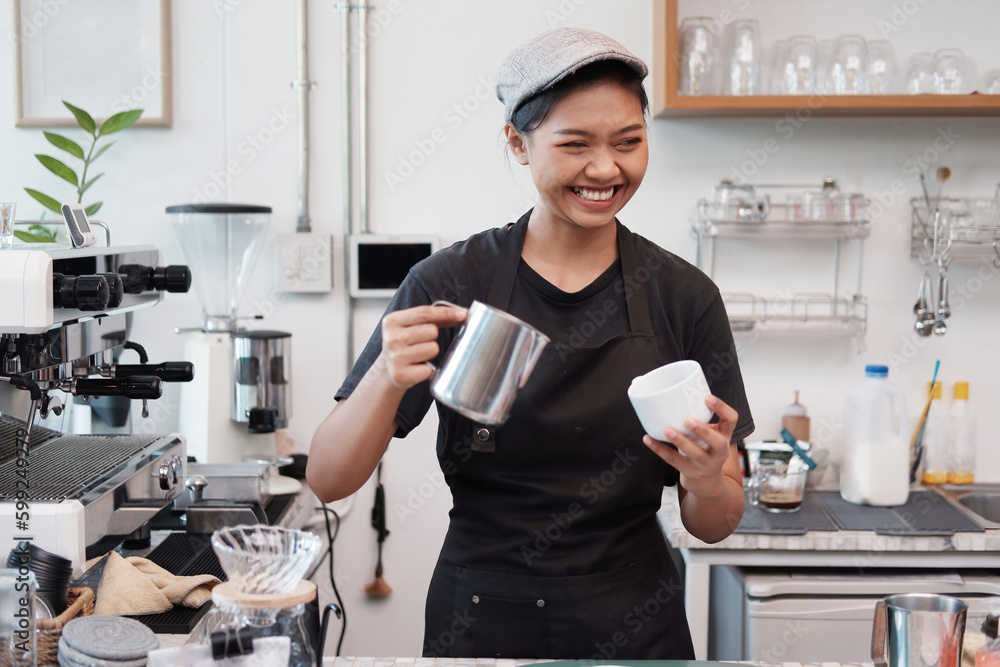 Smiling Asian barista young woman pouring hot black coffee into white ...