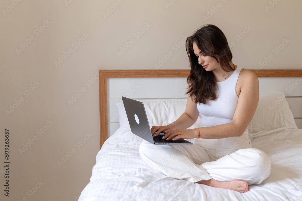 Teenage girl using laptop at home on bed. Young woman Study, typing ...