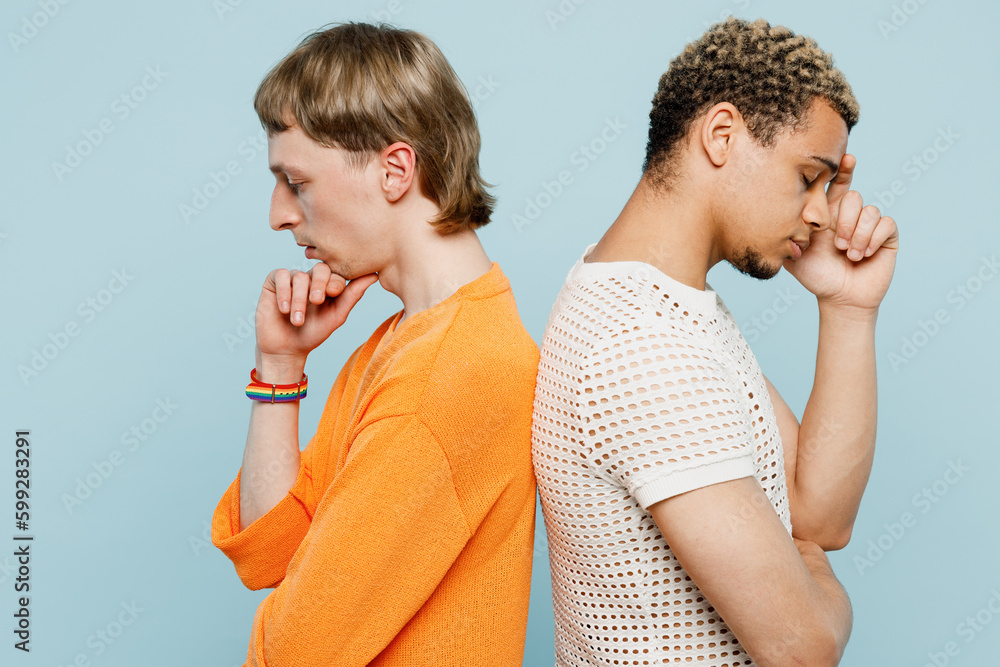 Side view sad young couple two gay men wear casual clothes together ...