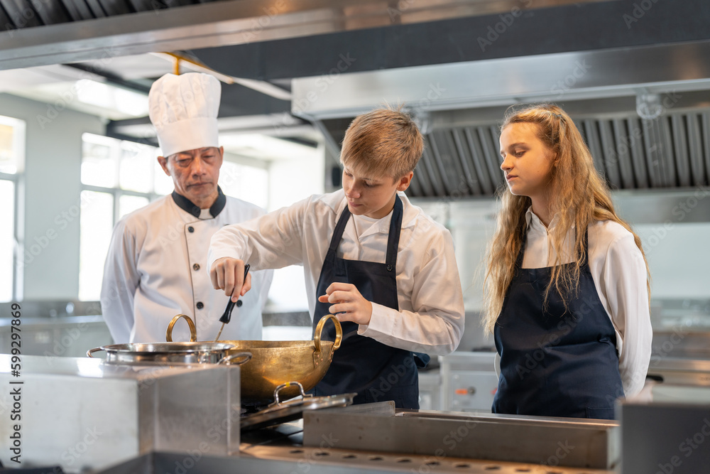 Group of student boy and girl studying cooking in class at school ...