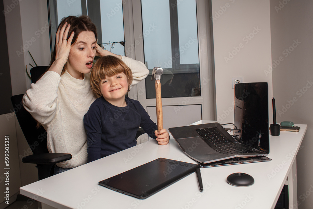 Happy child smashes mom's work laptop to spend more time together. The ...