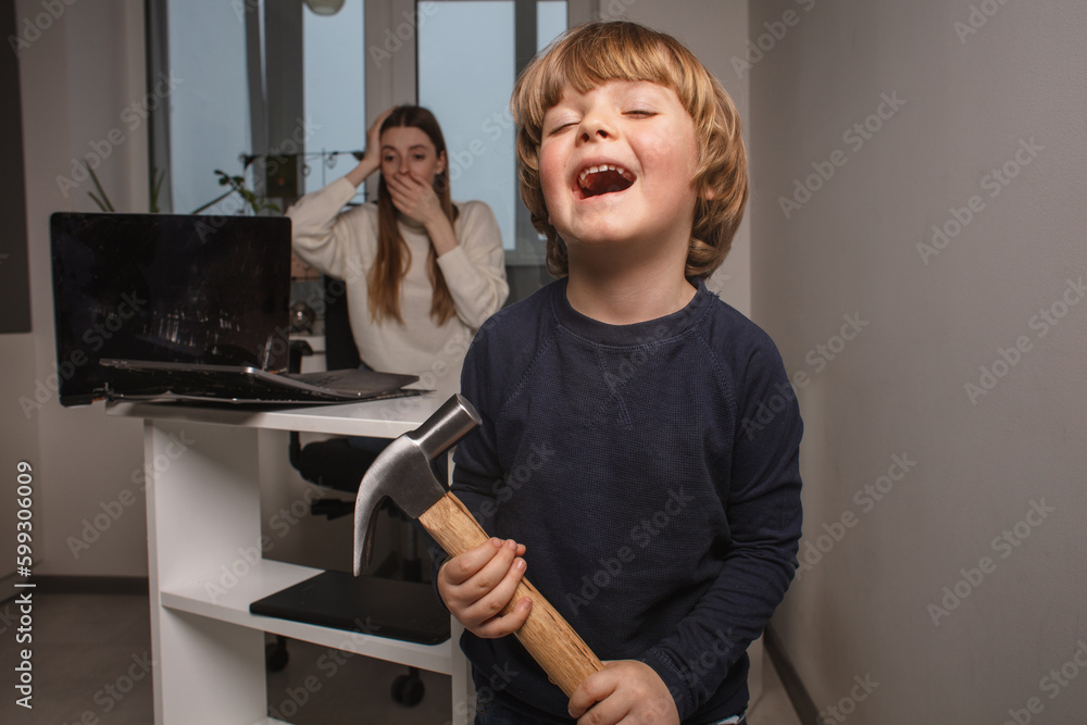 Happy child smashes mom's work laptop to spend more time together. The ...