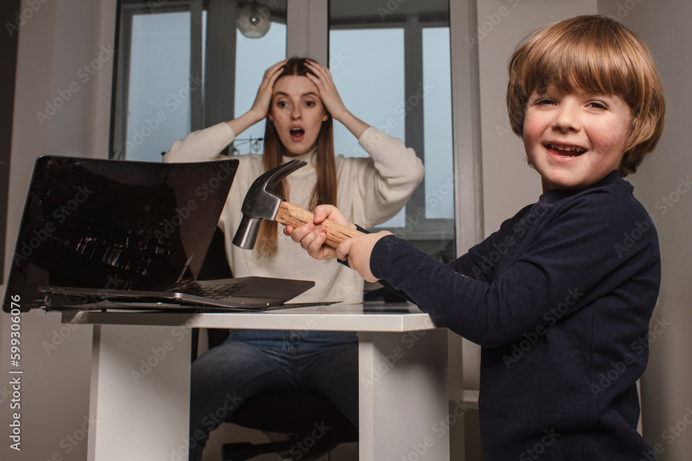 Happy child smashes mom's work laptop to spend more time together. The ...