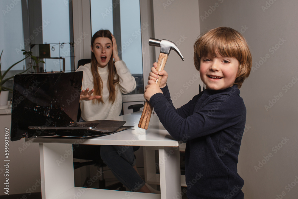 Happy child smashes mom's work laptop to spend more time together. The ...