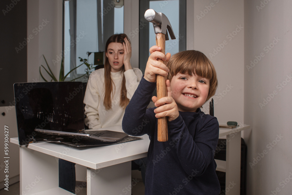 Happy child smashes mom's work laptop to spend more time together. The ...