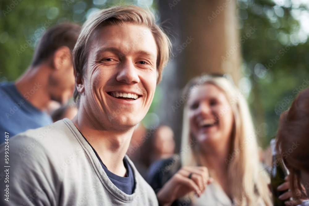 Enjoy an outdoor event. Portrait of a happy young man enjoying an ...