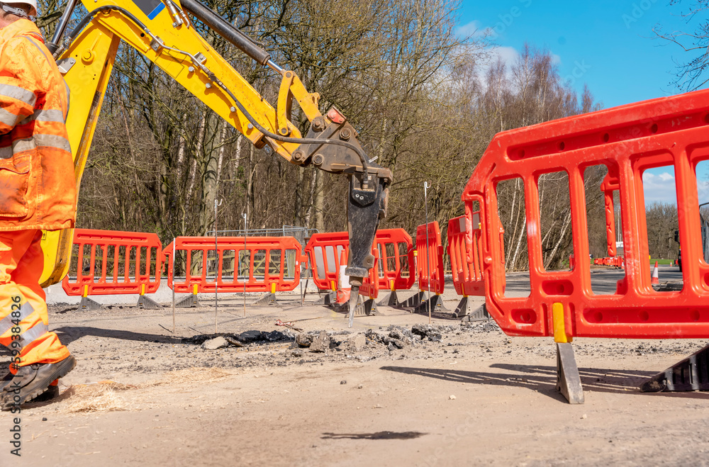 Excavator breaking and drilling the concrete and road surface. Large ...