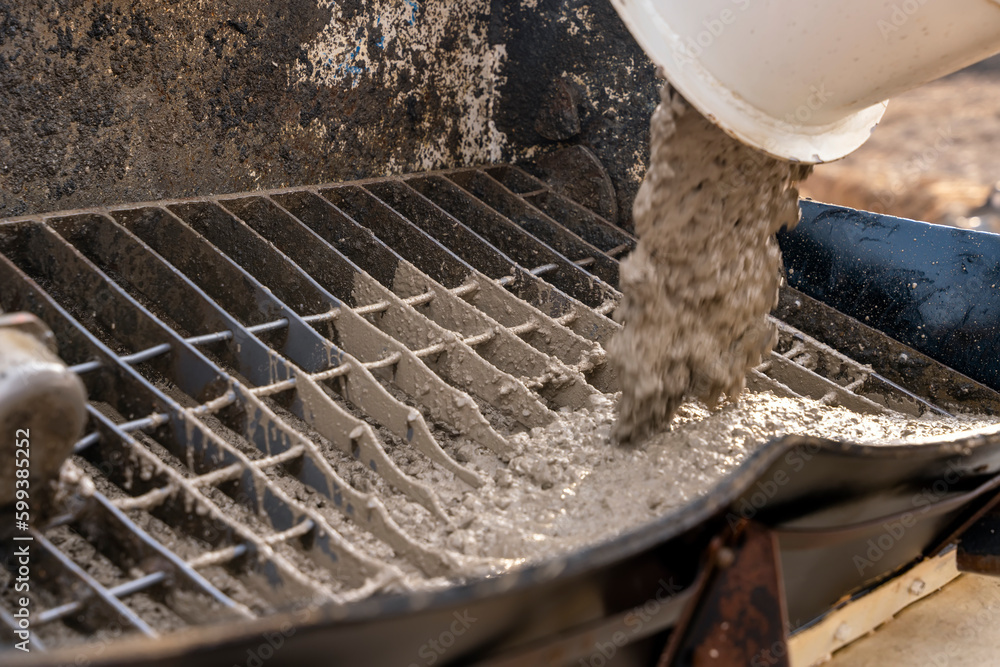 Concrete mixer truck delivered wet concrete and offloading it into ...