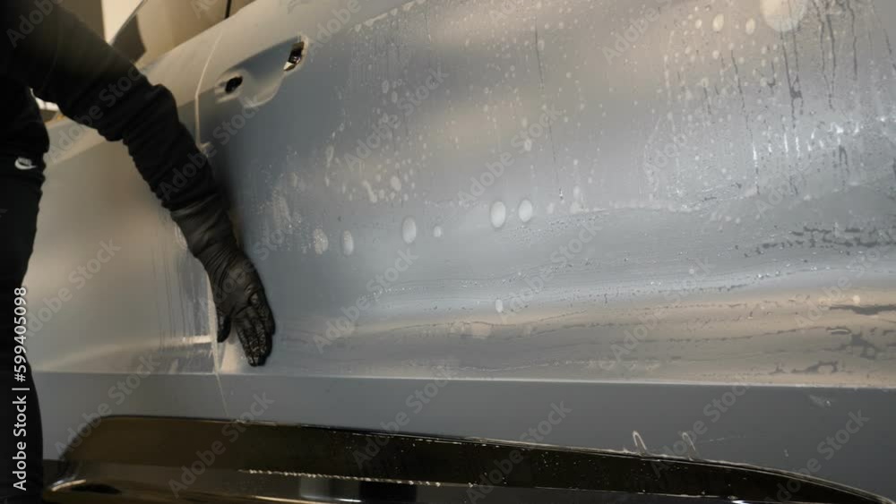 Close up to PPF installation process on a front headlight and hood. PPF ...