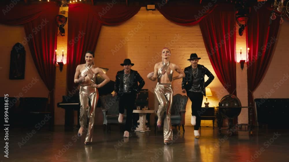 Dancers in glittering golden fashion costumes dancing in pairs. Funk ...