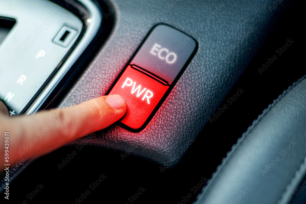 Hand pushing button in Power mode.The boost button accelerates the ...