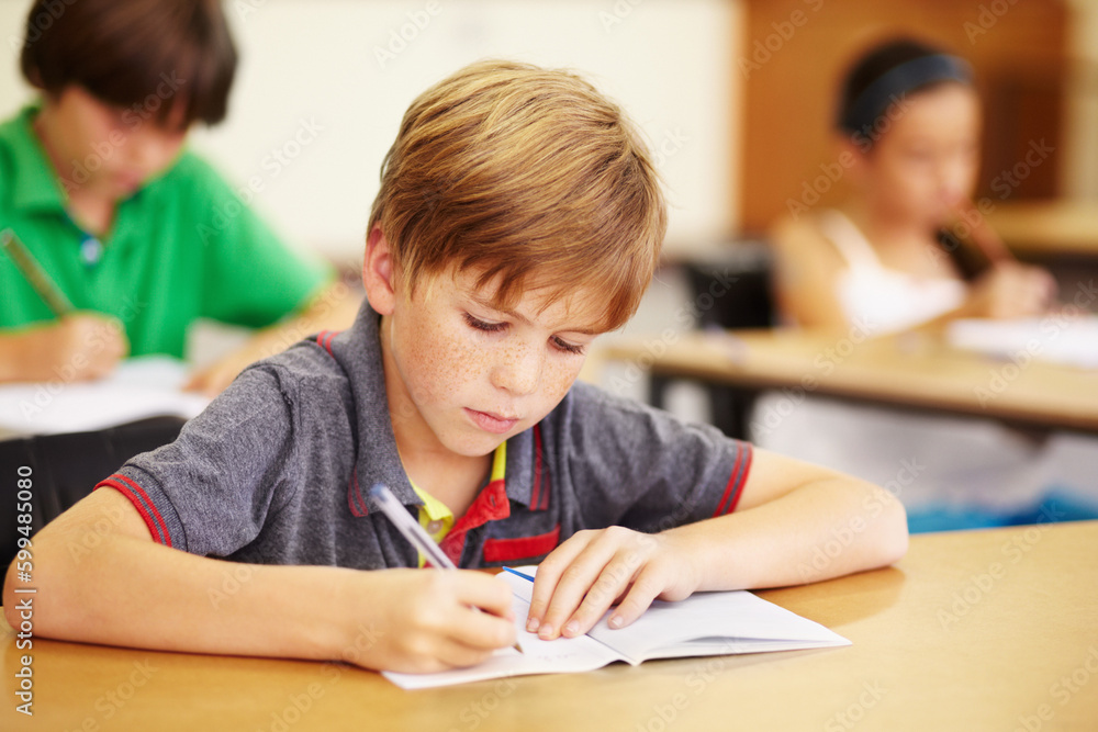 Boy kid, school classroom and writing test with focus, concentration ...