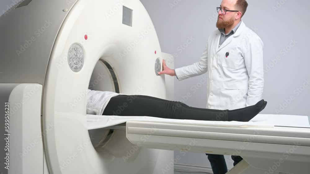 Young woman is undergoing a CT scan procedure. Pretty female in a ...