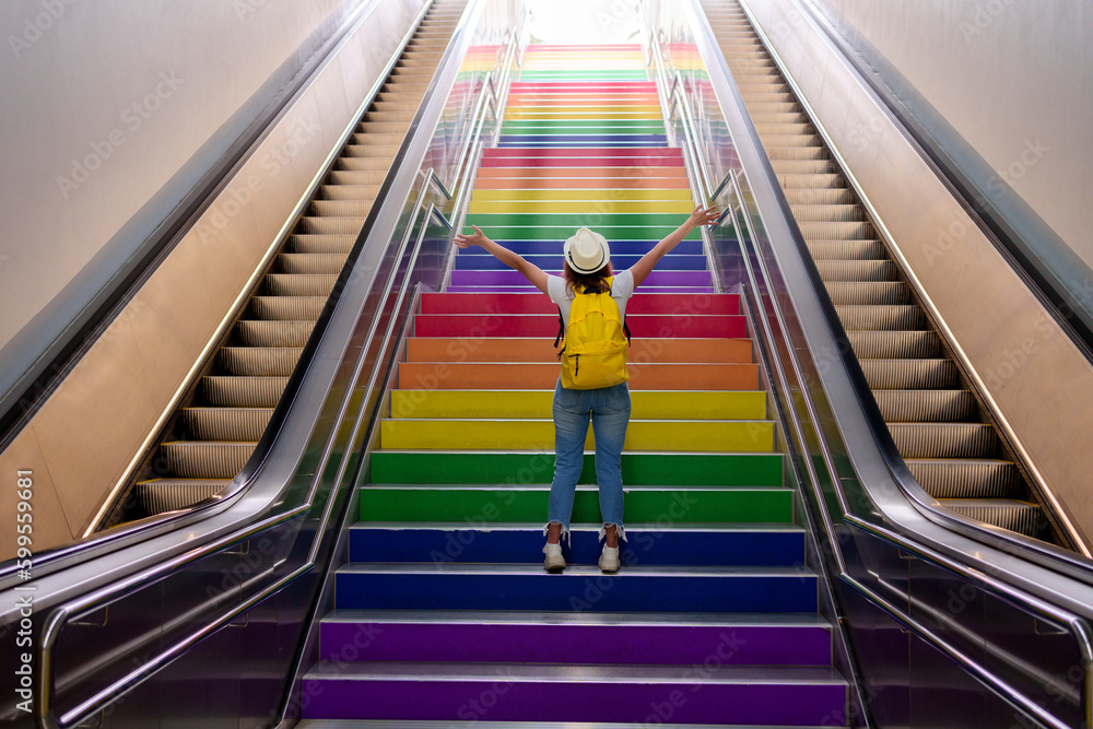 girl climbs the stairs with lgbt flag on gay pride day. Stock Photo ...