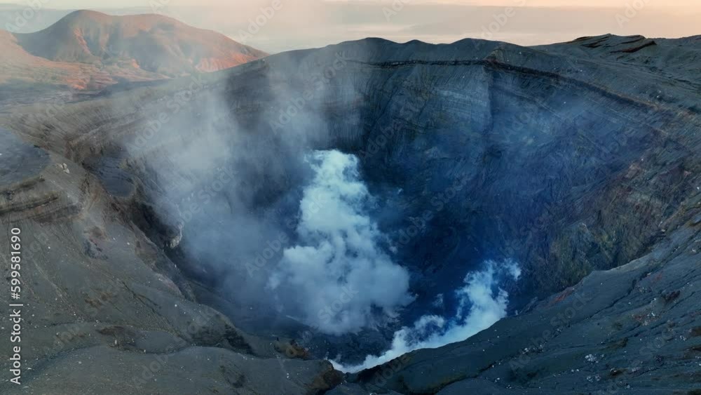 Smoke rising from the crater of active volcano in Japan, aerial view of ...