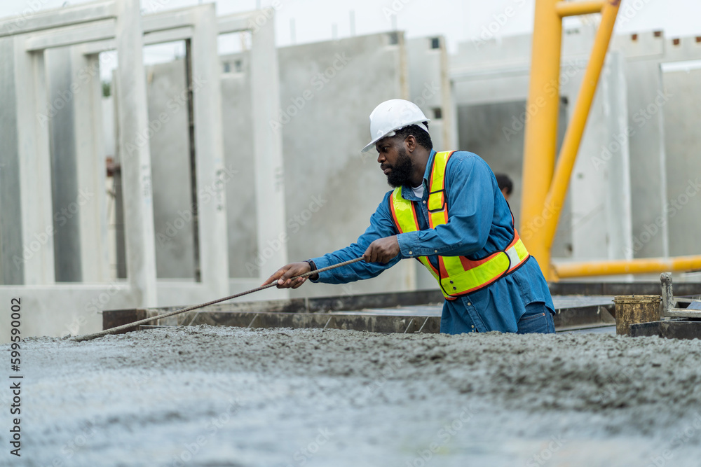 Male worker in a precast wall factory (Precast) is forming a wall with ...