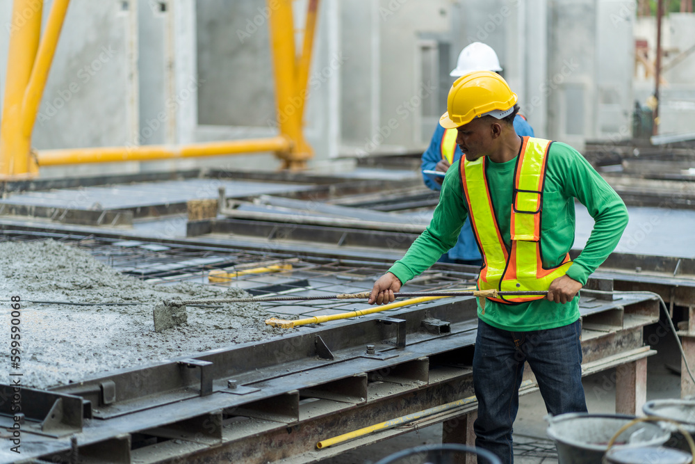 Male worker in a precast wall factory (Precast) is forming a wall with ...