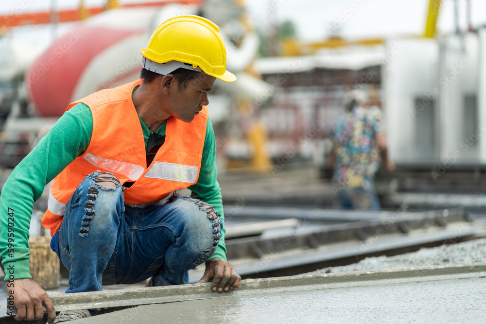 Male worker in a precast wall factory (Precast) is forming a wall with ...