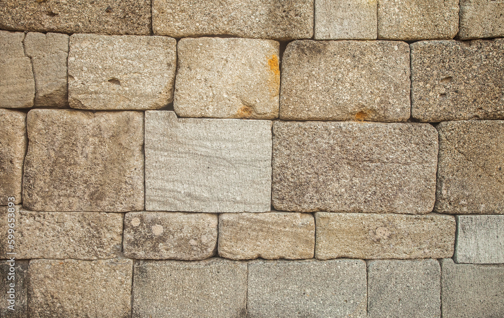 Ancient stone wall background and texture. These stone blocks were used to build temples in the ...