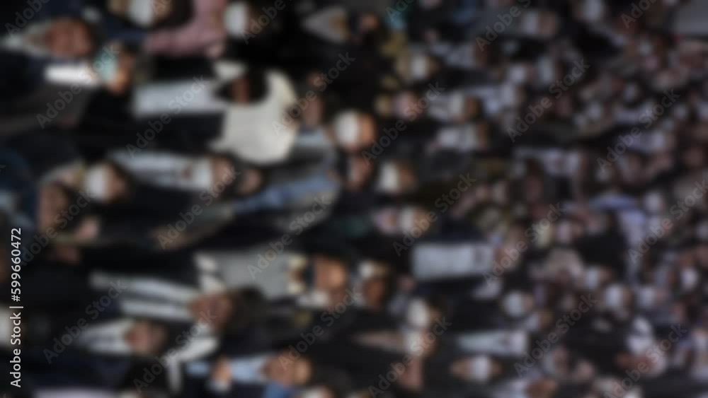 Vertical Screen blurred defocused of large crowd of people walking ...